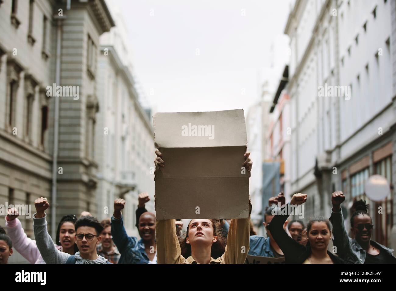 Group of demonstrators with blank banner protesting on the street ...