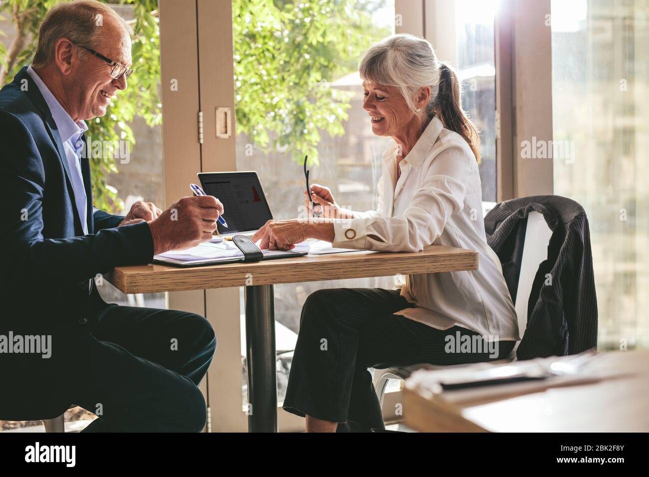 Woman signing paperwork hi-res stock photography and images - Alamy