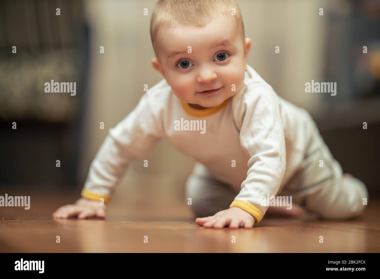Smiling crawling baby boy at home on floor.Bright portrait of adorable ...