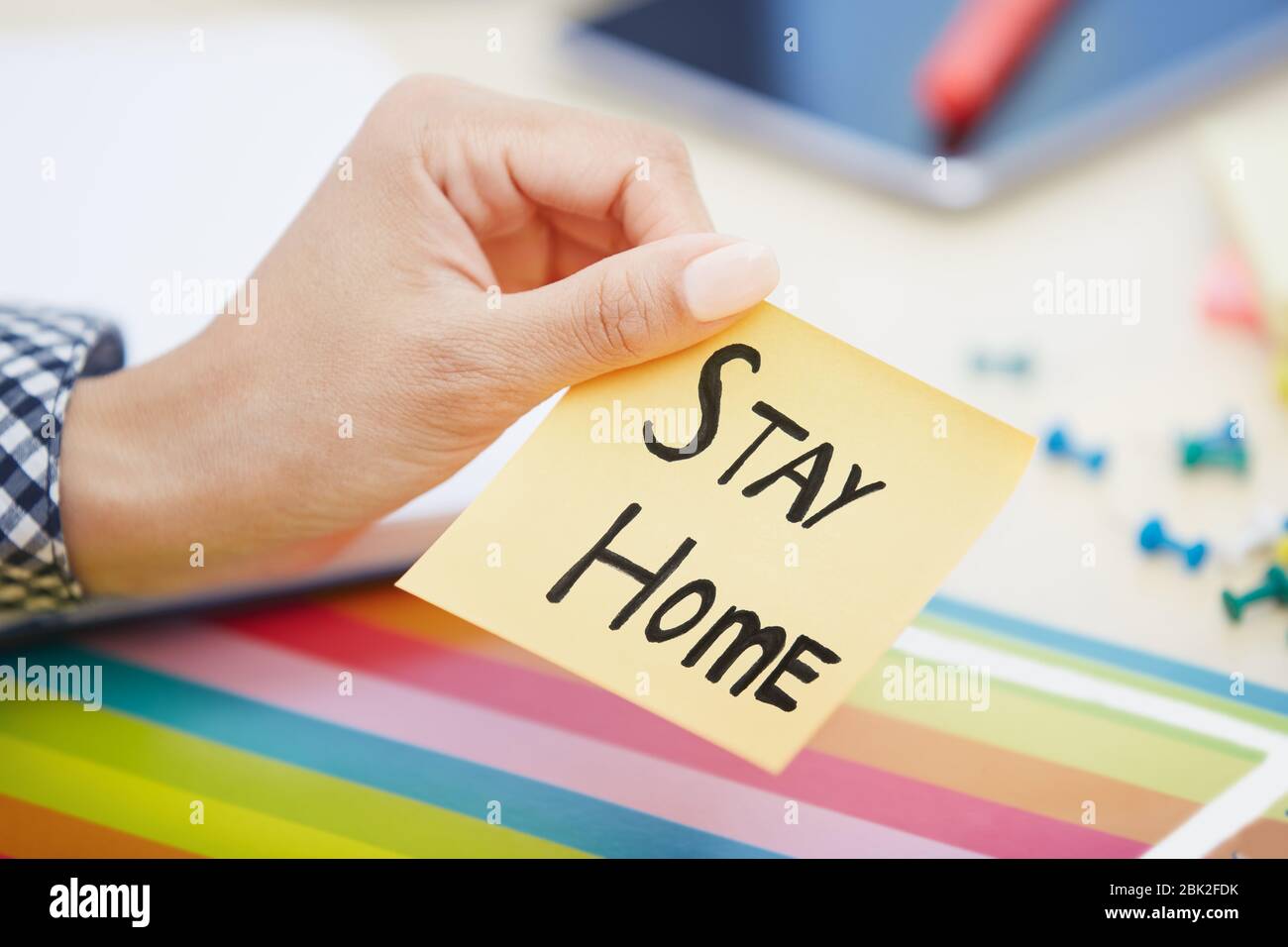 Human hand holding adhesive note with Stay Home text Stock Photo - Alamy