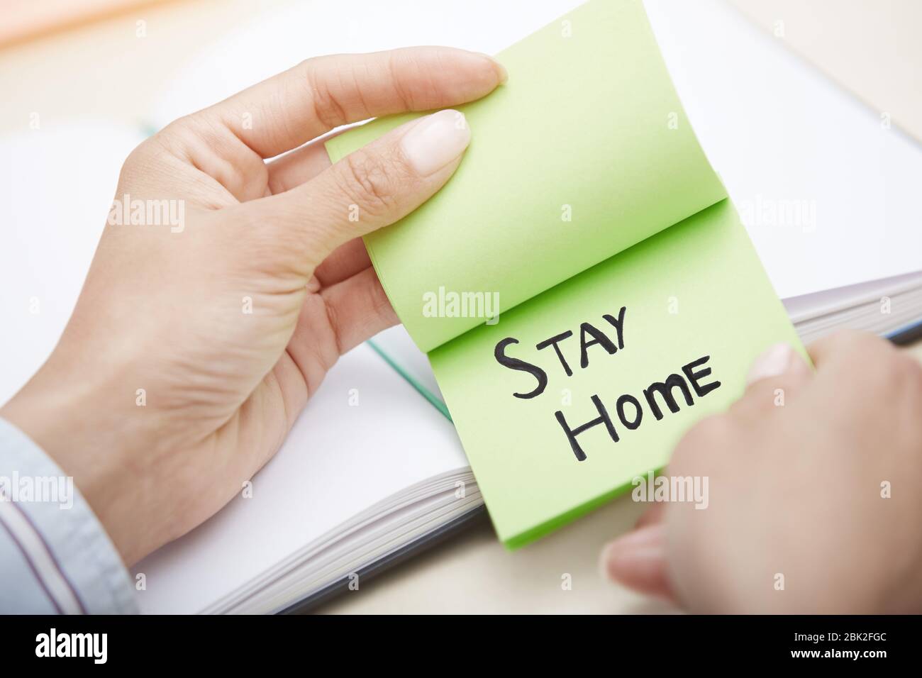 Hands holding sticky note with Stay Home text Stock Photo - Alamy