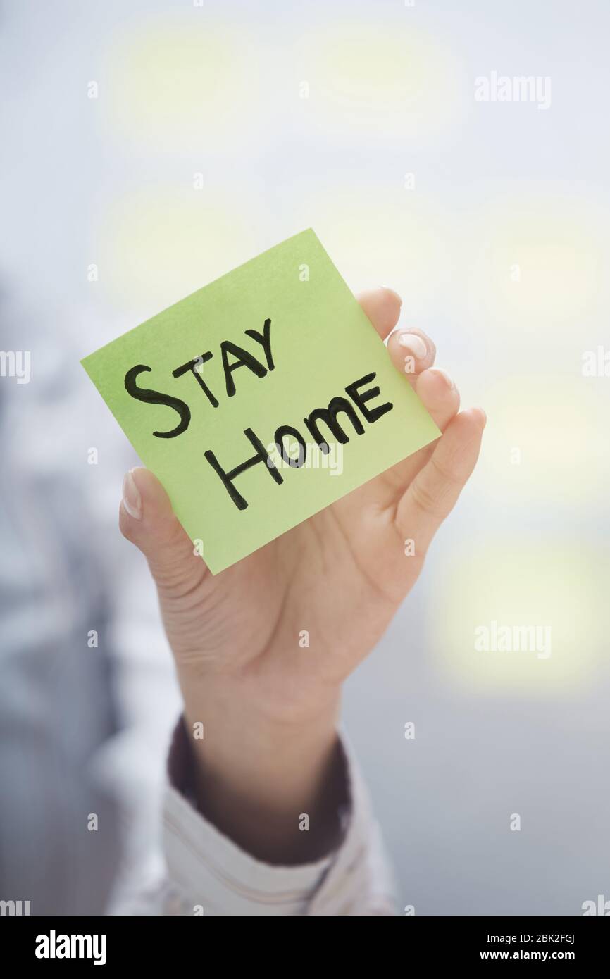 Hands holding sticky note with Stay Home text Stock Photo - Alamy