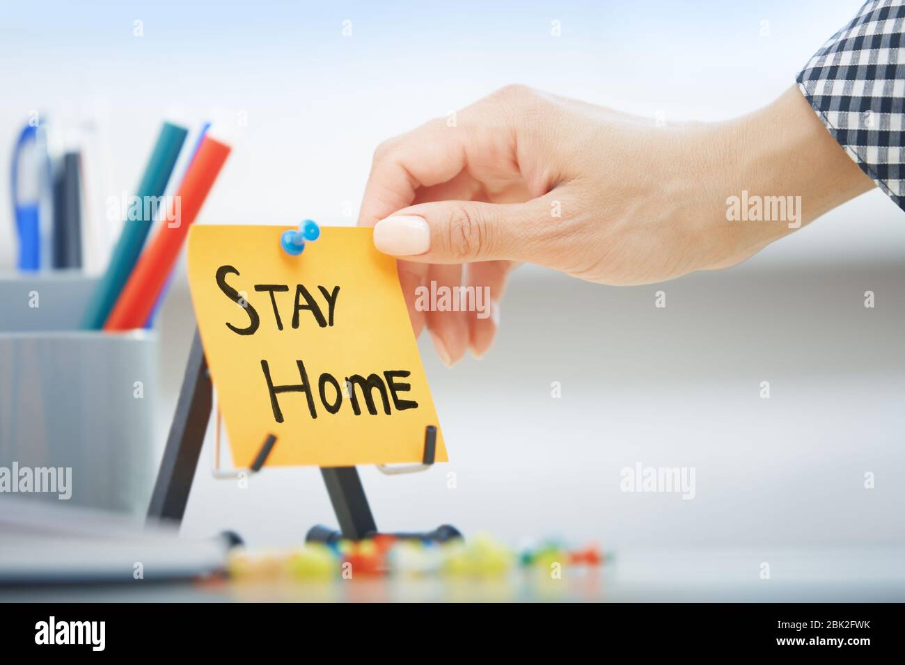 Human hand holding adhesive note with Stay Home order Stock Photo - Alamy