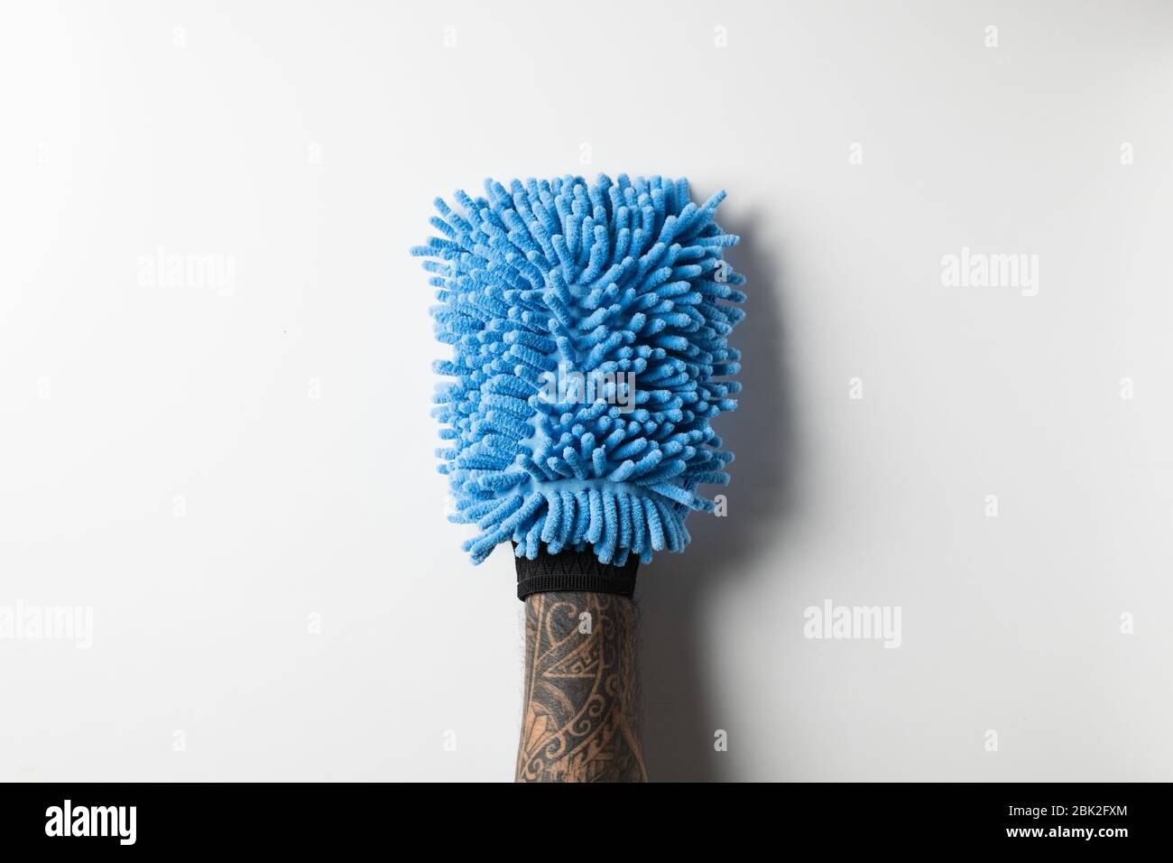 top view of hand with blue cleaning rag isolated on white background ...