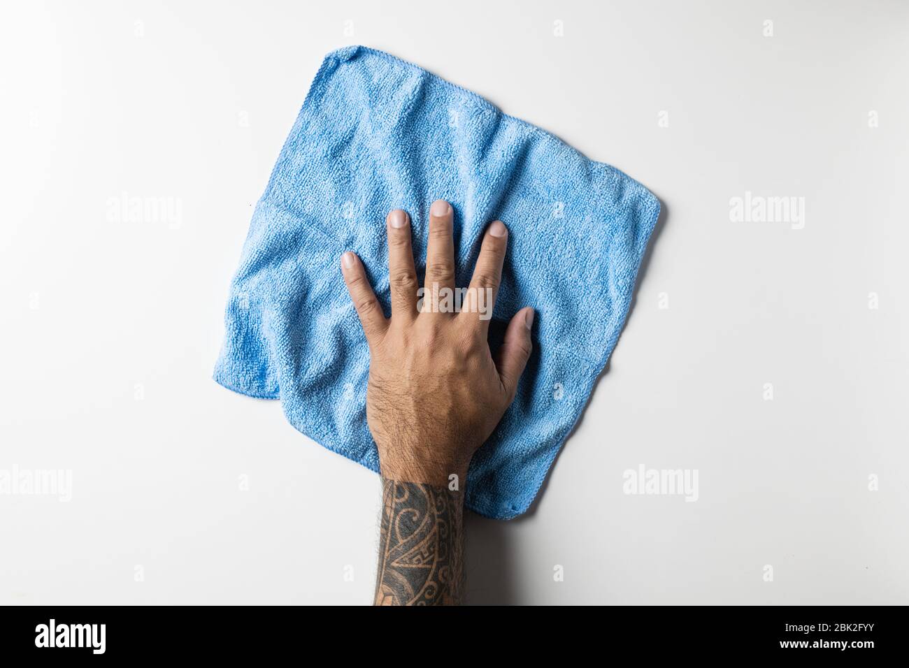 top view of hand with blue cleaning rag isolated on white background ...