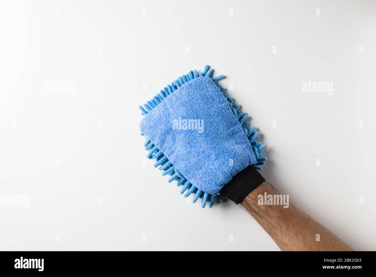 top view of hand with blue cleaning rag isolated on white background ...