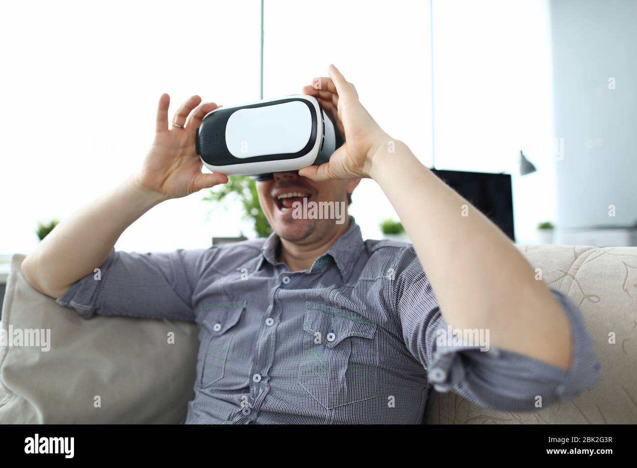 Guy using VR at home Stock Photo - Alamy