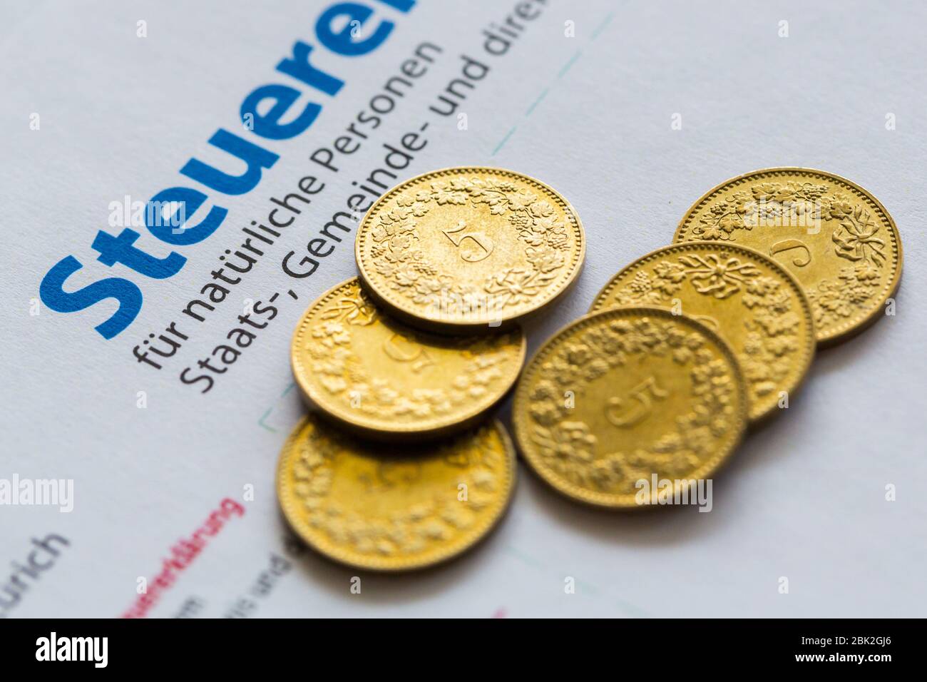six golden coins on paper of Swiss tax declaration form, Canton of ...