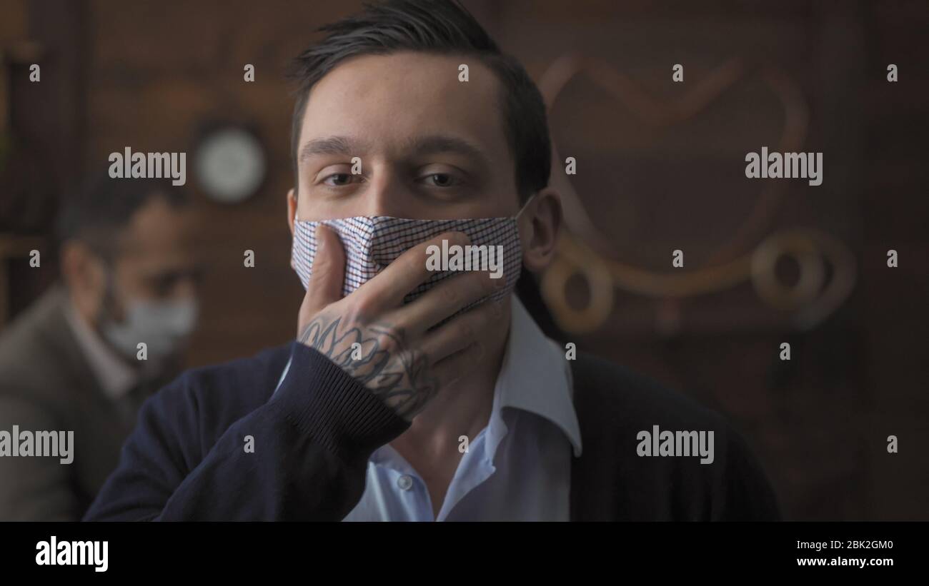 Masked Office Worker Sneezes Covering His Mouth With His Hand Stock ...