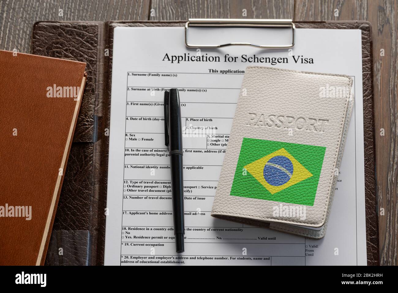 Application form, pen and a Brazilian passport Stock Photo - Alamy