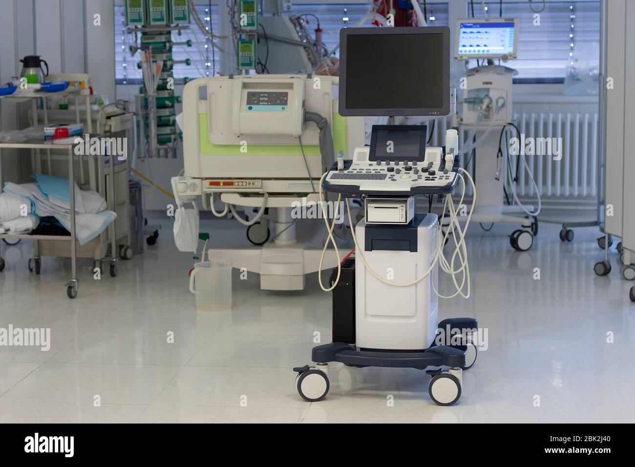 Ultrasound machine, on background patient connected to medical ...