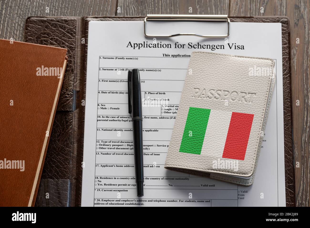 Application form, pen and an Italian passport Stock Photo - Alamy