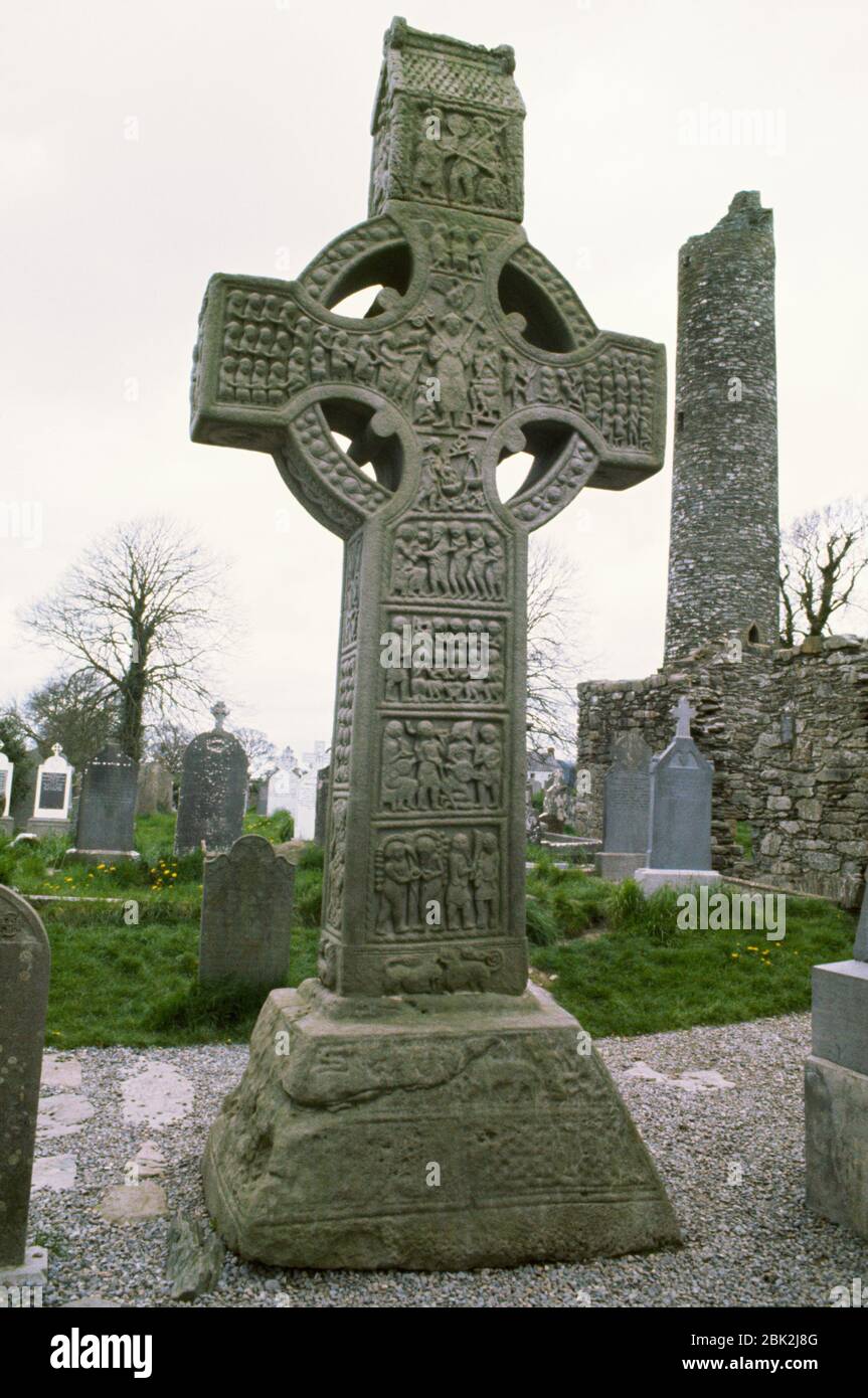 The ruined round tower & E face of Muiredach's Cross, Monasterboice, Co ...