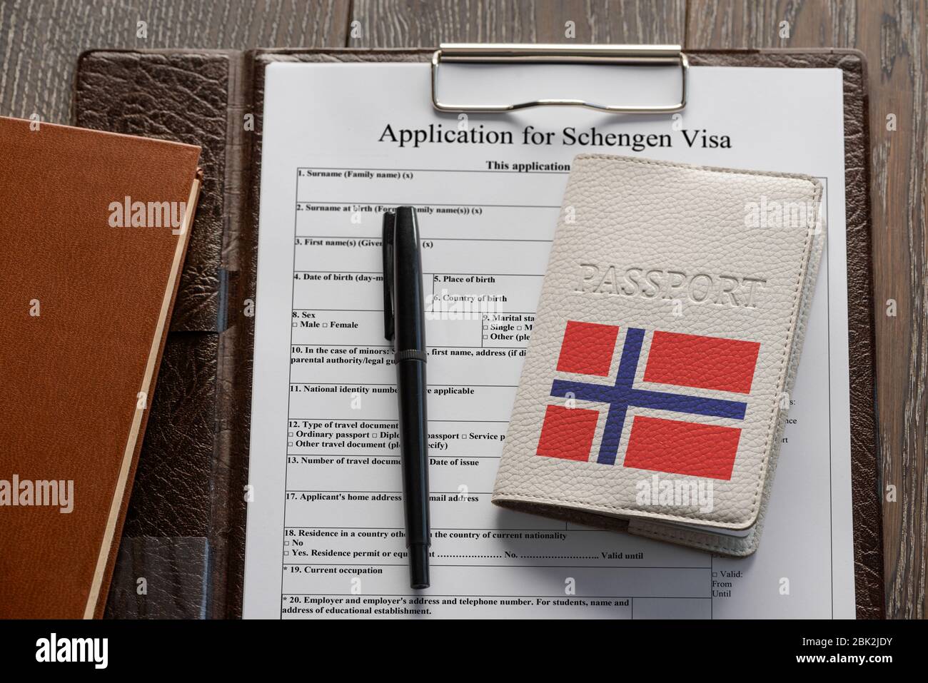 Application form, pen and a Norwegian passport Stock Photo - Alamy