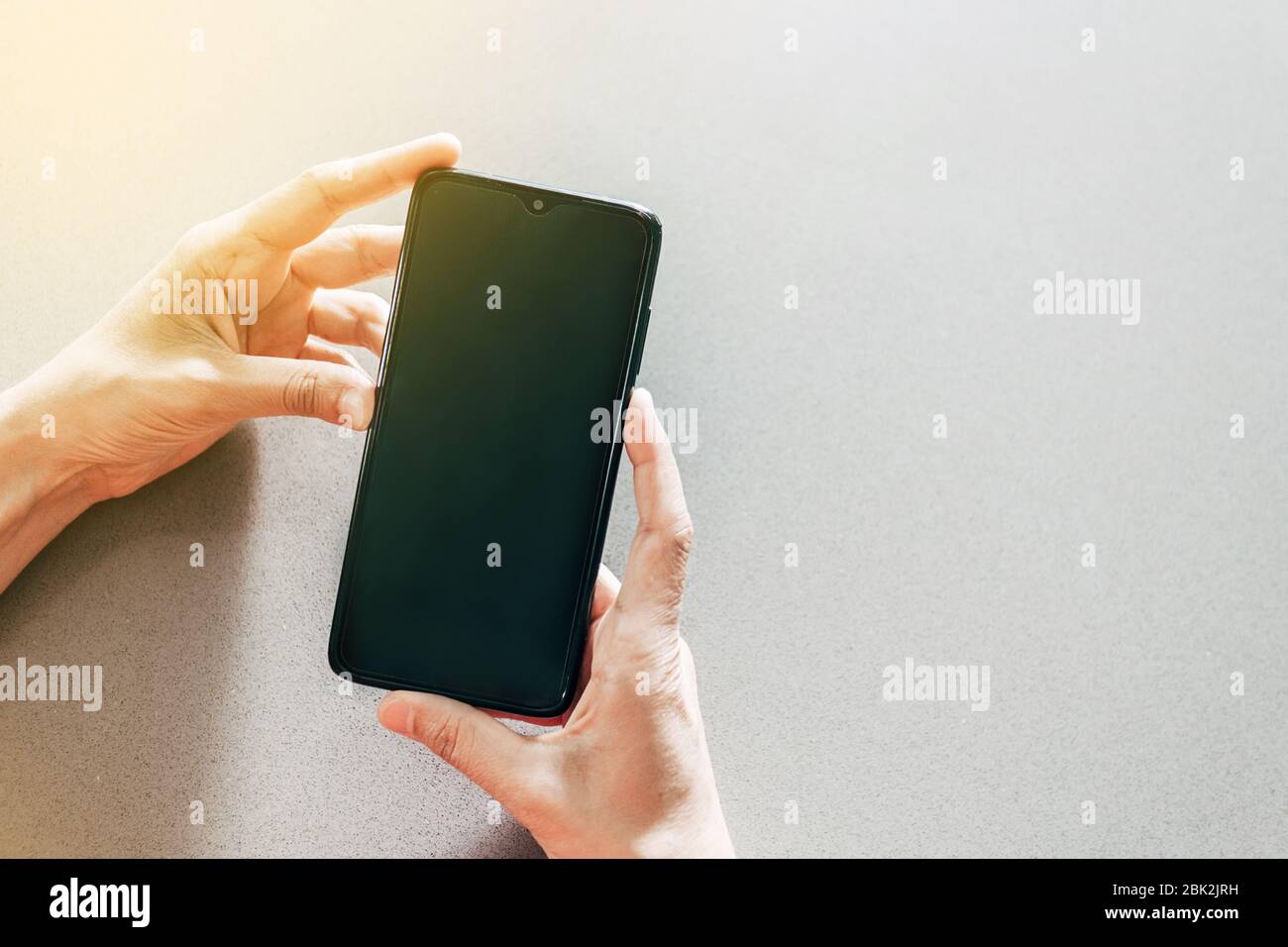 Two hands holding phone hi-res stock photography and images - Alamy