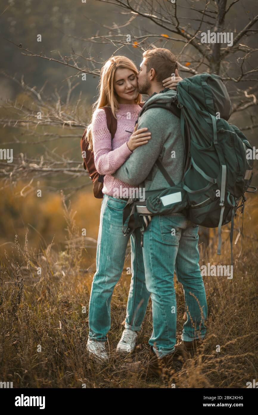 Couple In Love Of Backpackers Rest Stopping On Cliff Edge Stock Photo ...