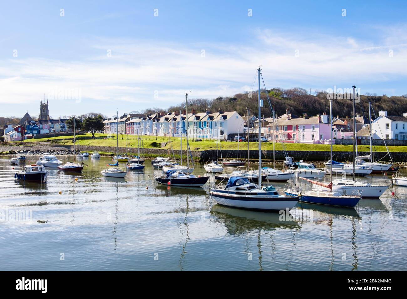 View along Afon Aeron River estuary with boats moored in harbour at ...