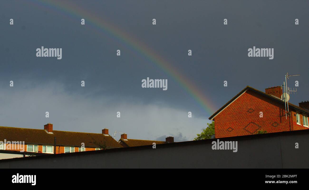 Rainbow over houses Stock Photo - Alamy