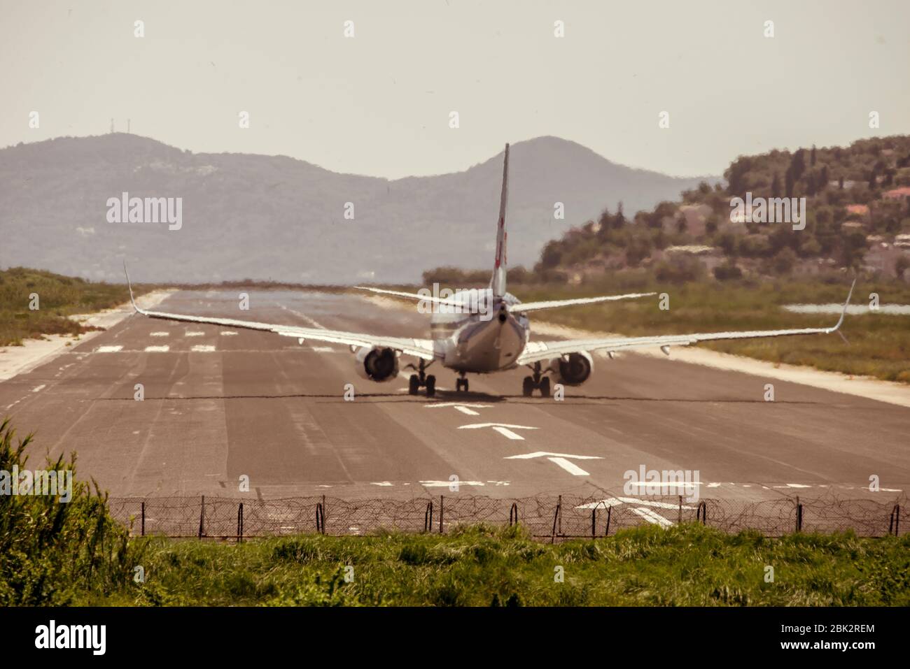 Thomson aeroplane taxiing on the runway at Corfu International Airport ...