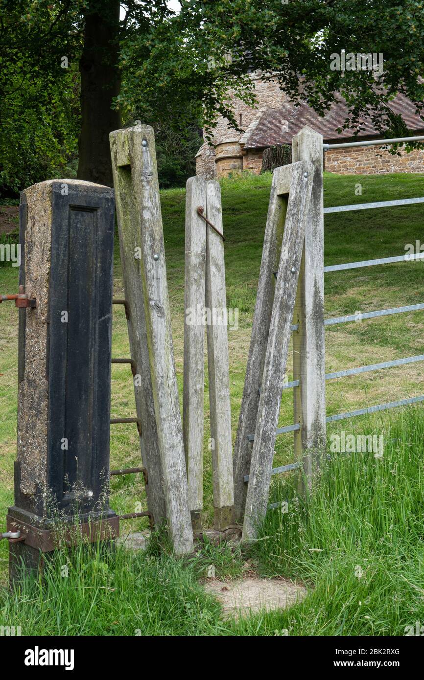 A squeeze stile set into a fence on a countryside footpath in ...
