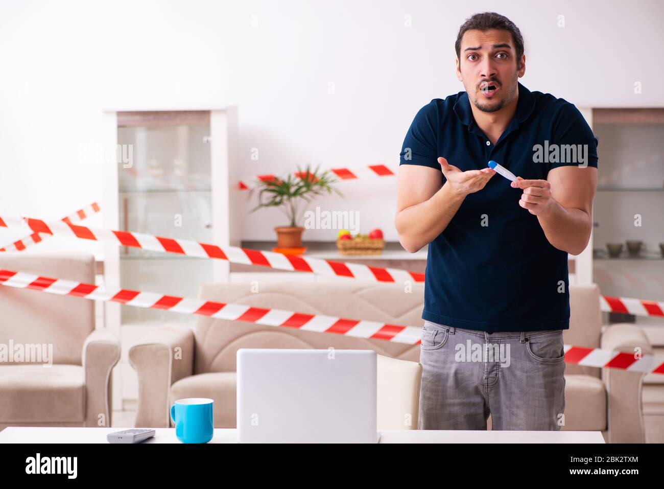 Young man feeling bored at the home in self-isolation concept Stock ...