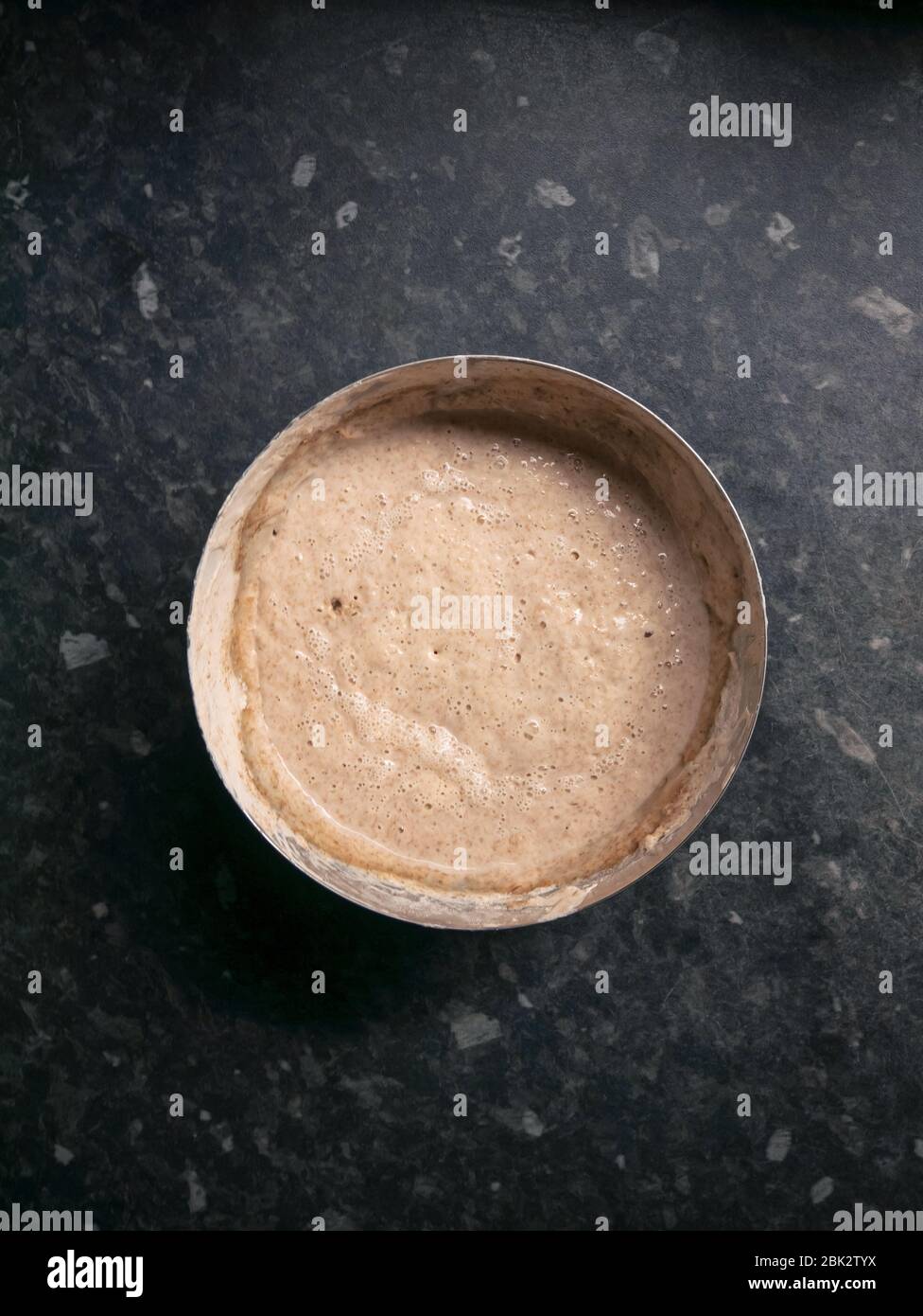 A top down view of a bubbling sourdough starter on a kitchen top Stock ...