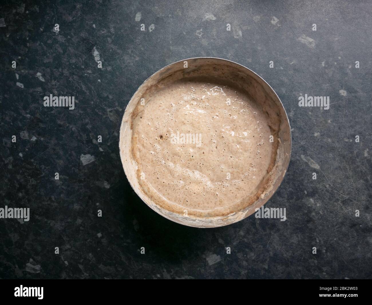 A top down view of a bubbling sourdough starter on a kitchen top Stock ...