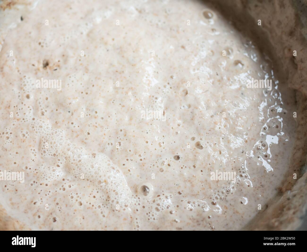 A close up view of a sourdough starter slowly bubbling away Stock Photo ...