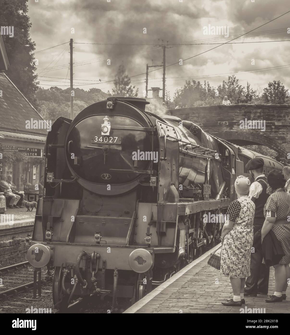 Monochrome, nostalgic front view of vintage UK steam train arriving at ...