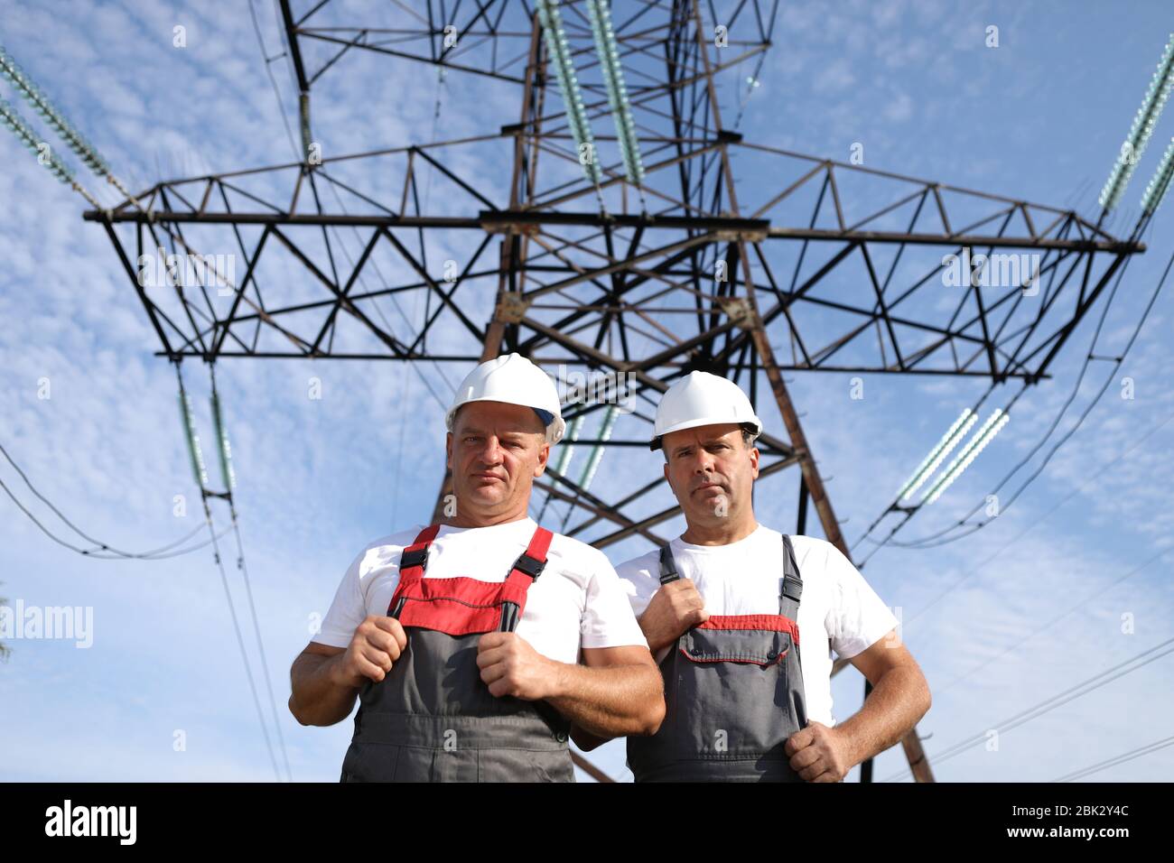 Two adult male electricians show like. Two workers of power plants on ...