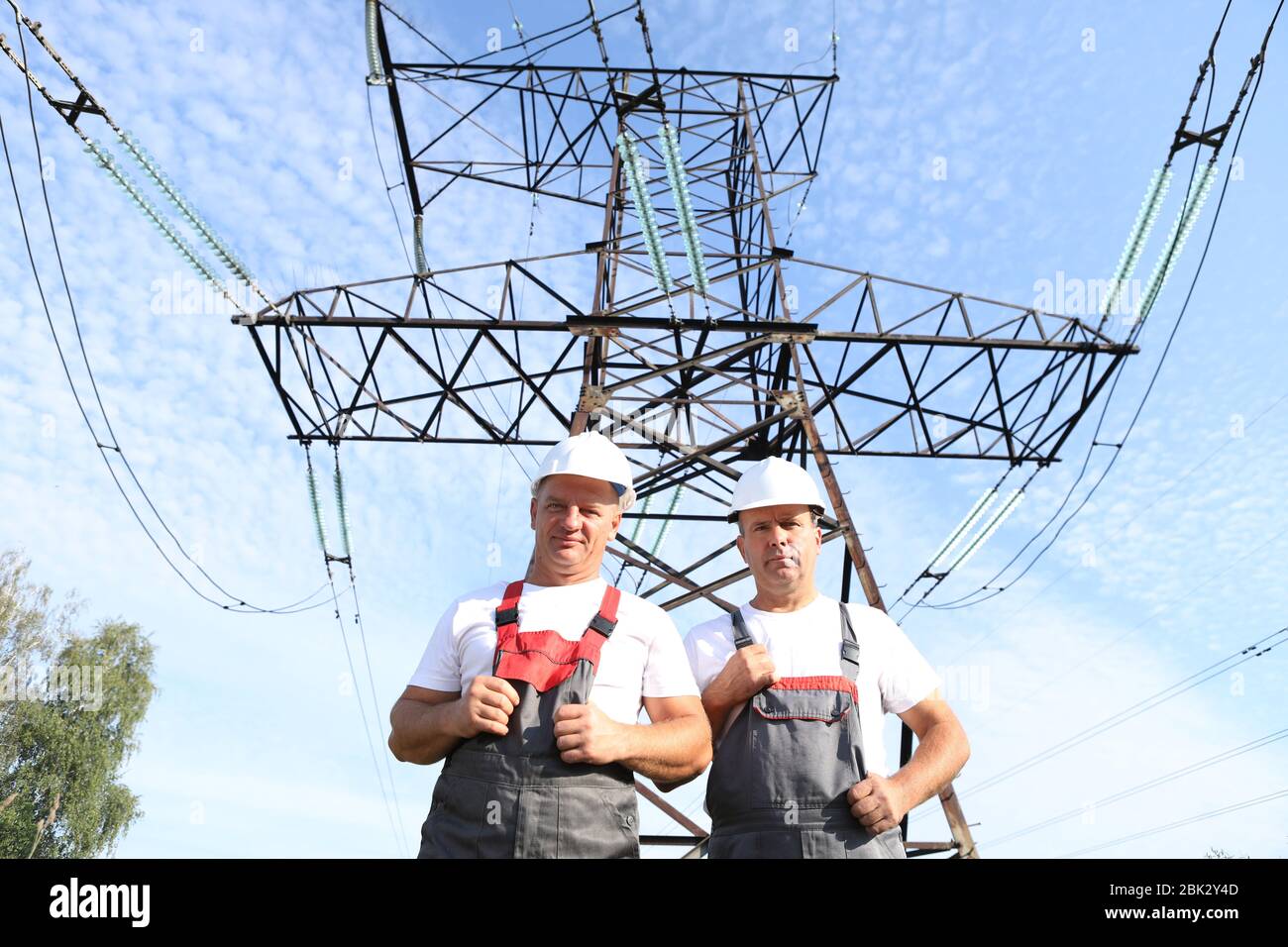 Two adult male electricians show like. Two workers of power plants on ...