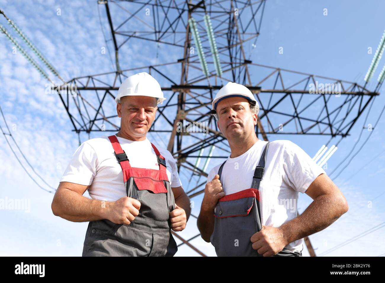 Two adult male electricians show like. Two workers of power plants on ...