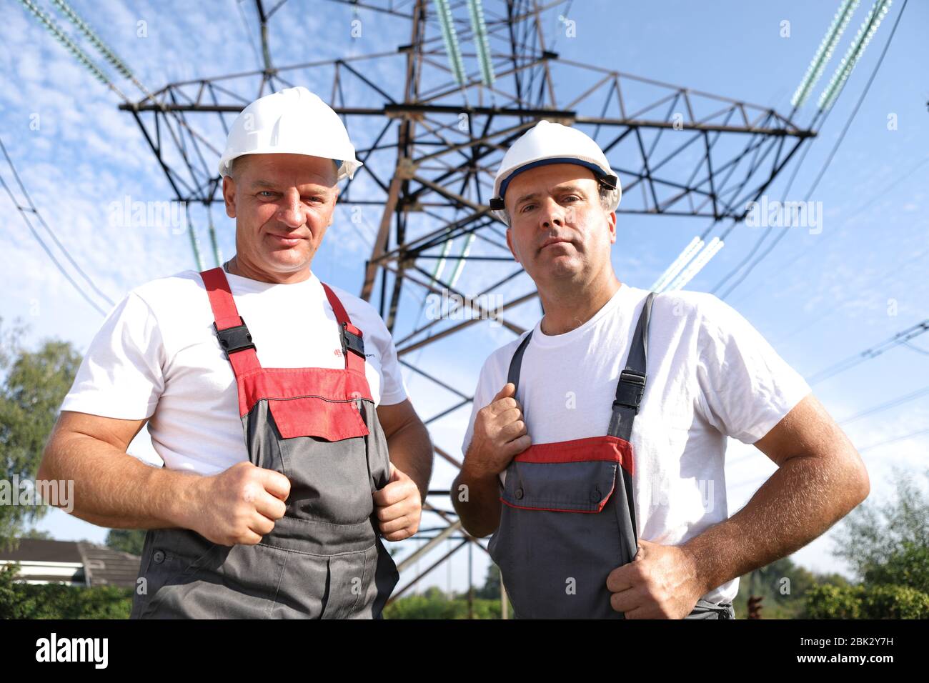 Two adult male electricians show like. Two workers of power plants on ...