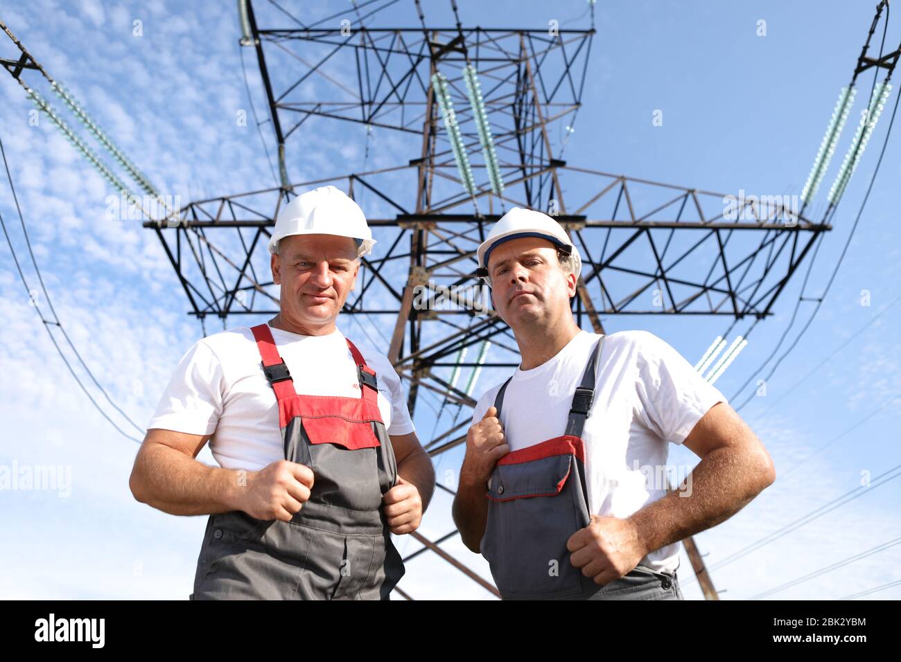 Two adult male electricians show like. Two workers of power plants on ...