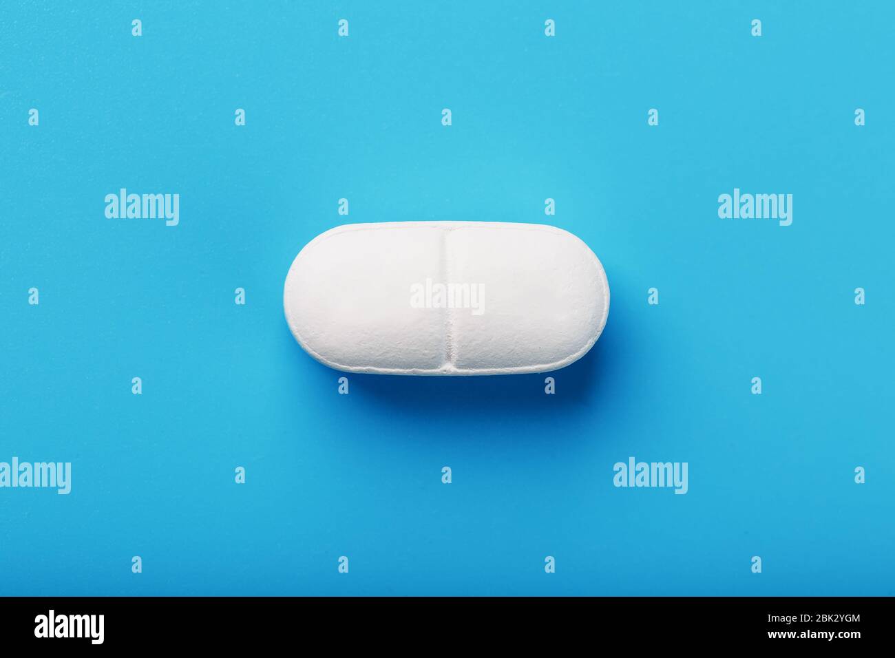 Medicinal tablet on a blue background, isolated Stock Photo - Alamy