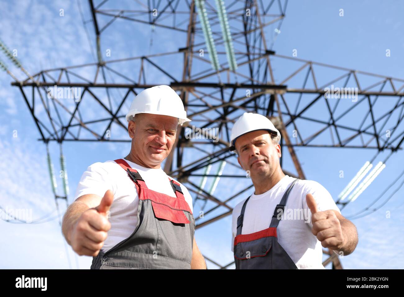 Two adult male electricians show like. Two workers of power plants on ...