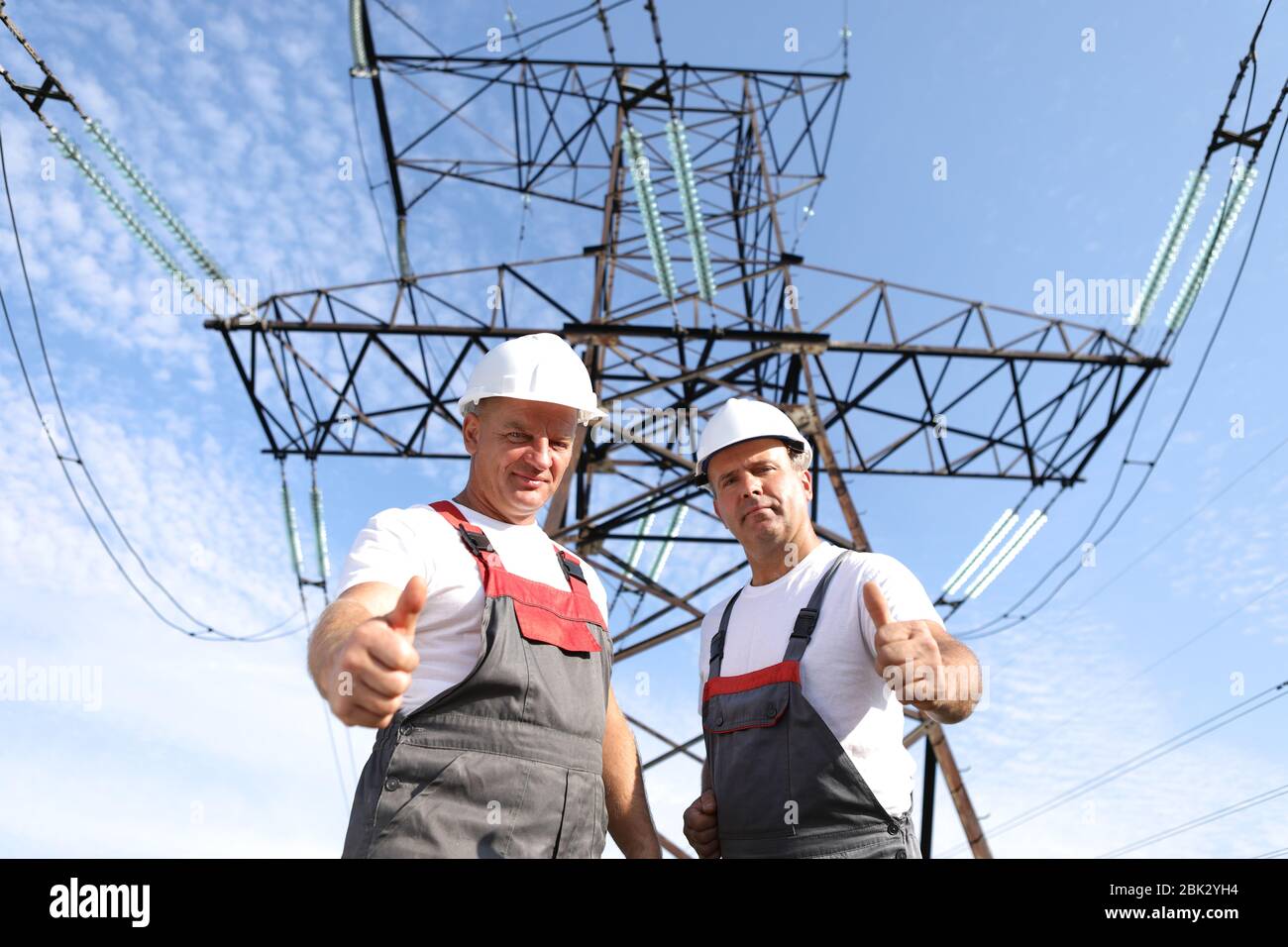 Two adult male electricians show like. Two workers of power plants on ...