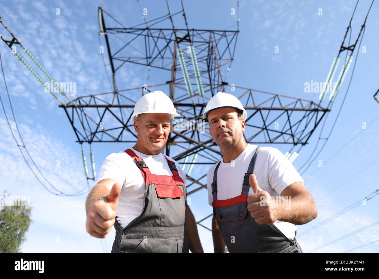 Two adult male electricians show like. Two workers of power plants on ...