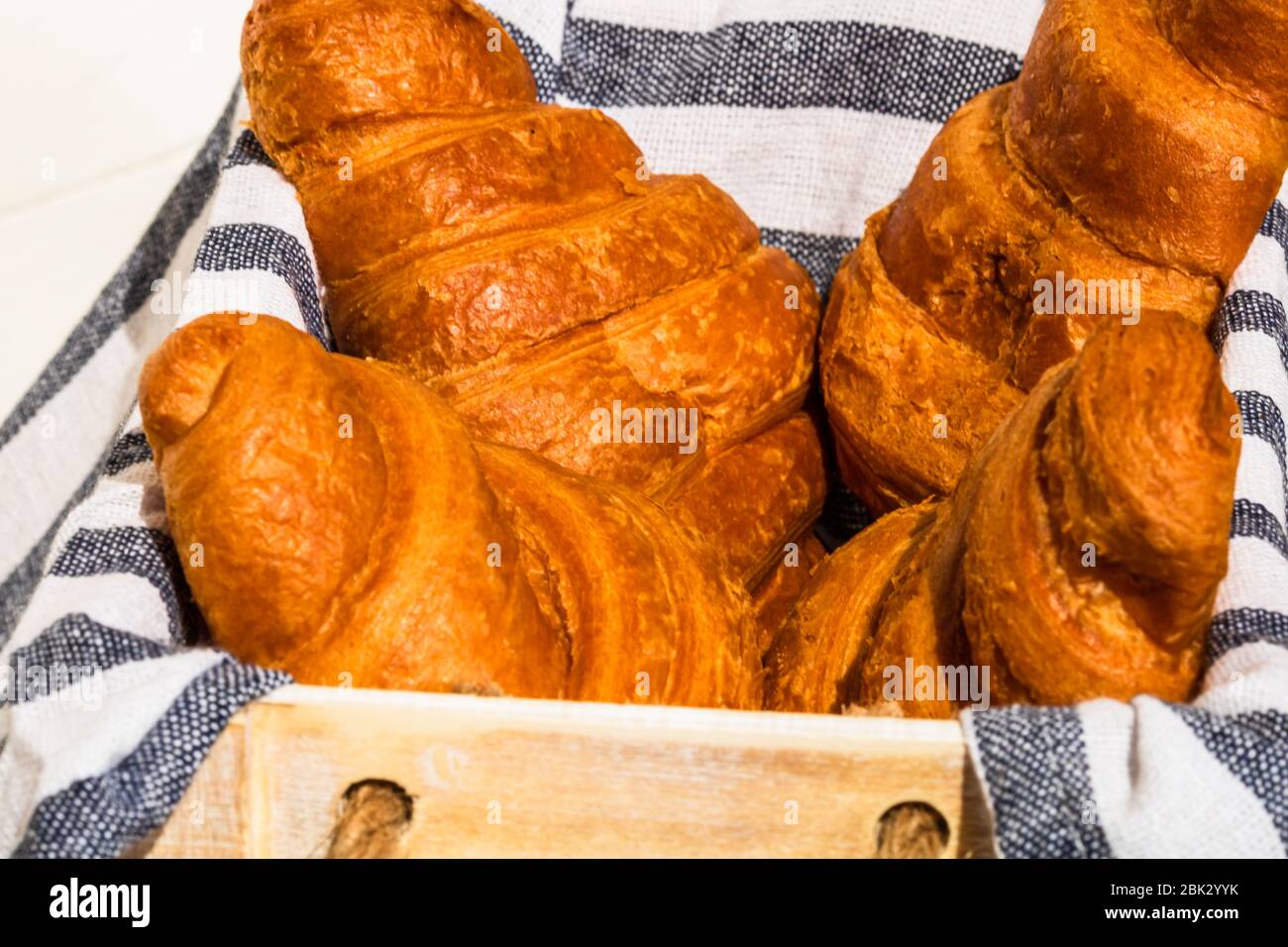 Fresh croissant, puff pastry and buttered french croissant on wooden ...