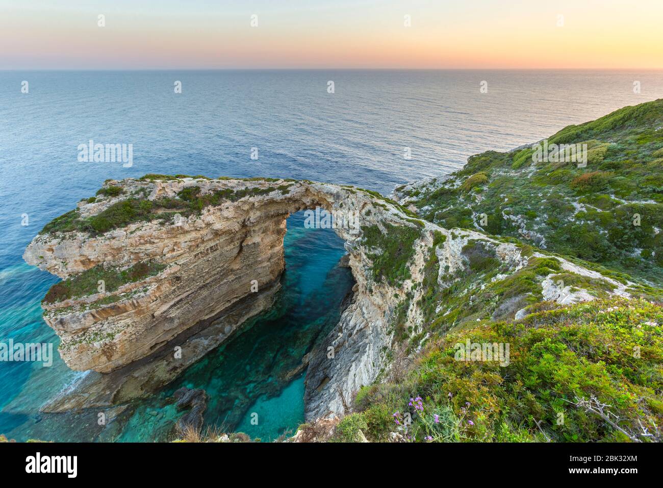 Landscape view of sunset over Tripitos Arch, Paxos, Greece Stock Photo ...