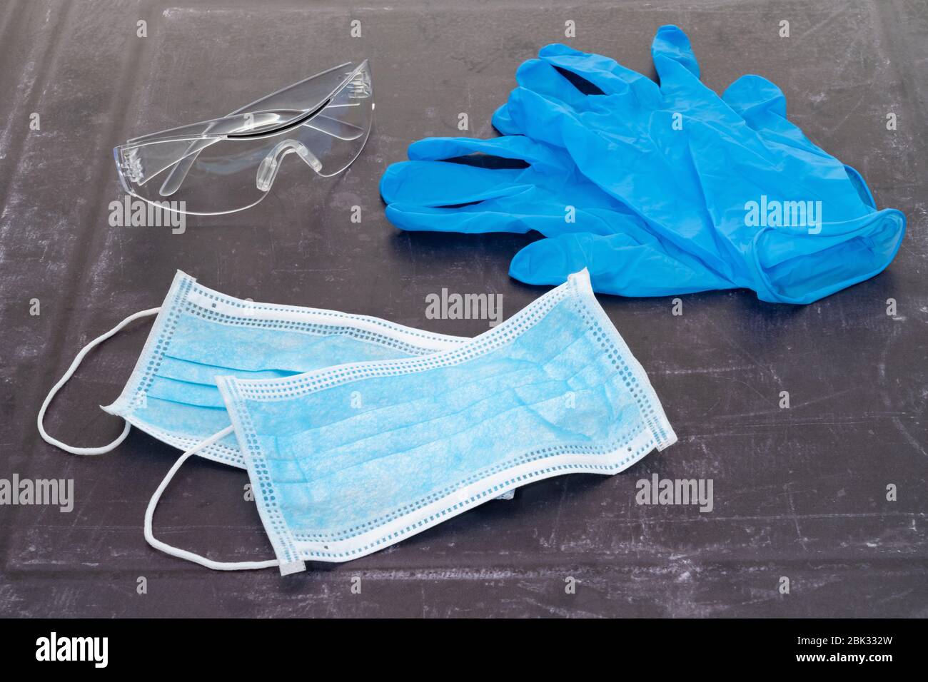 Blue medical face mask with latex gloves and protective eye wear ...