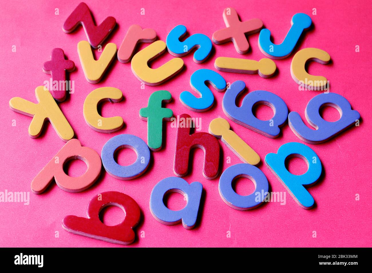 English Alphabets. Colorful wooden English small letters on a pink ...