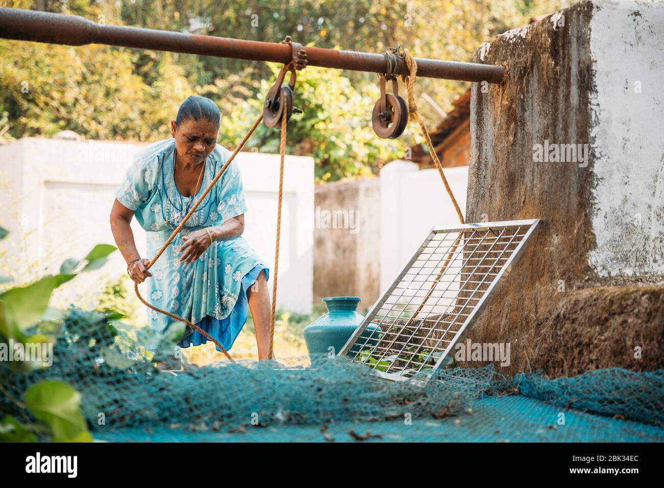 Velha Goa, Goa, India - February 18, 2020: Woman Draws Water From Well ...