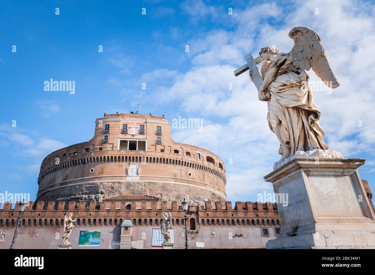 A statue on Ponte Sant' Angelo the bridge of angels with Castel Sant' Angelo the former ...