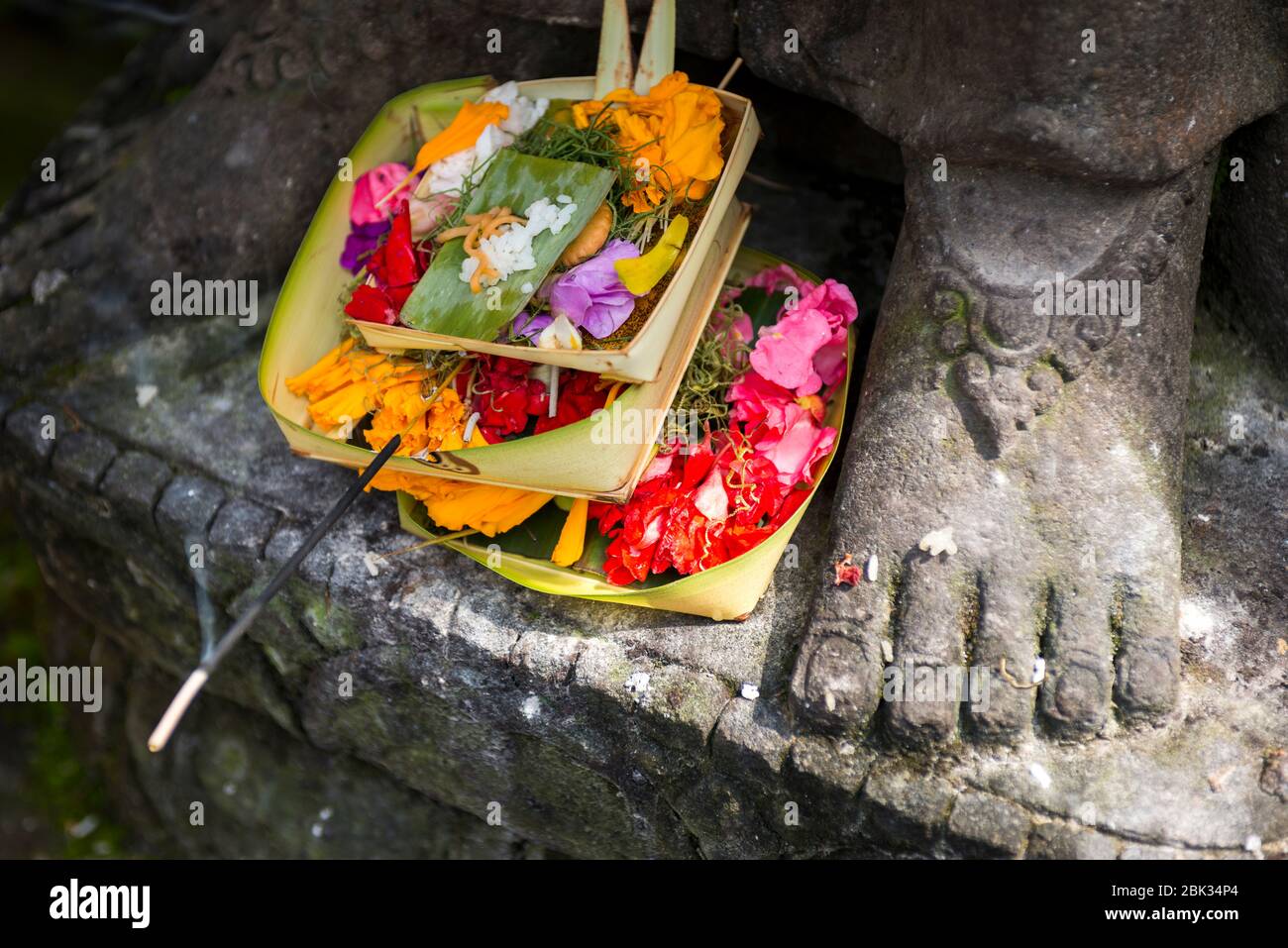 Canang sari placed at the feet of a statue, Ubud, Bali, Indonesia Stock ...