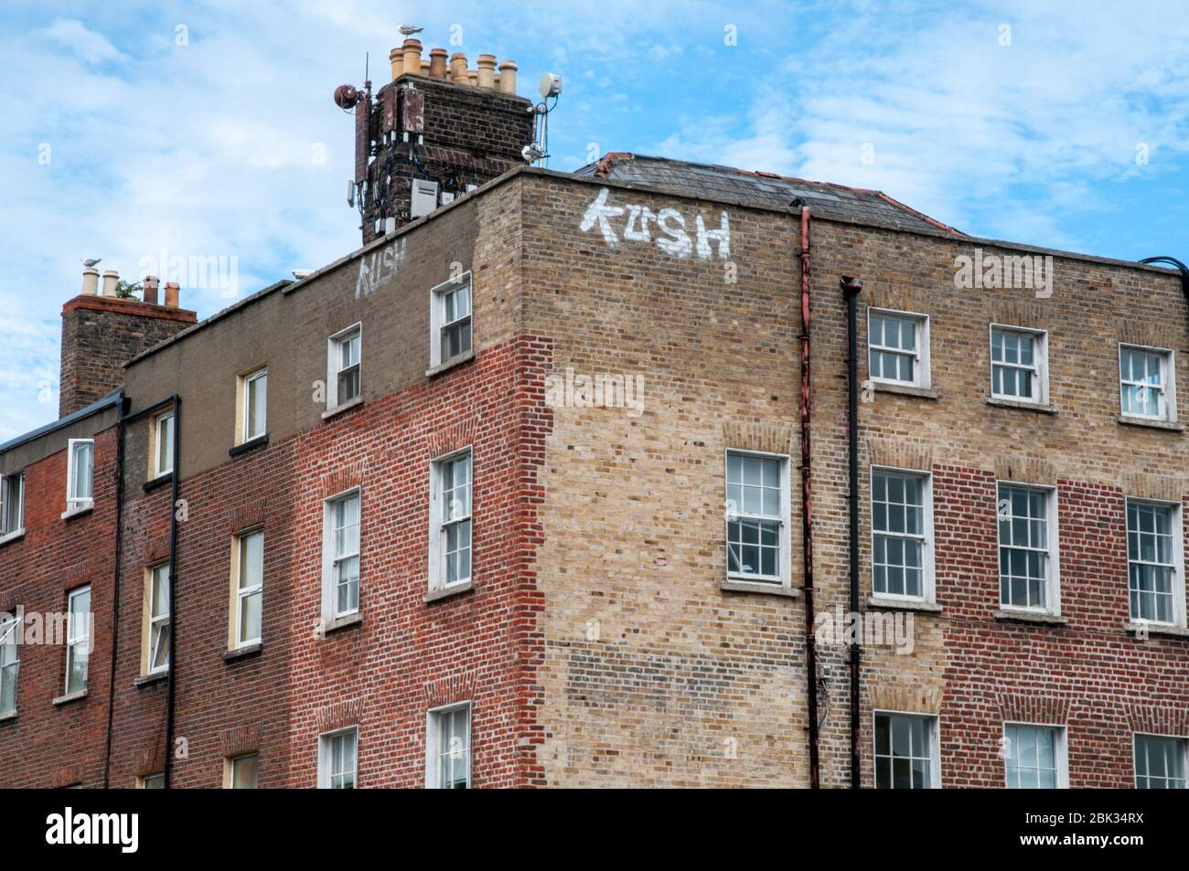 A neglected four storey period brick building facade on corner of ...