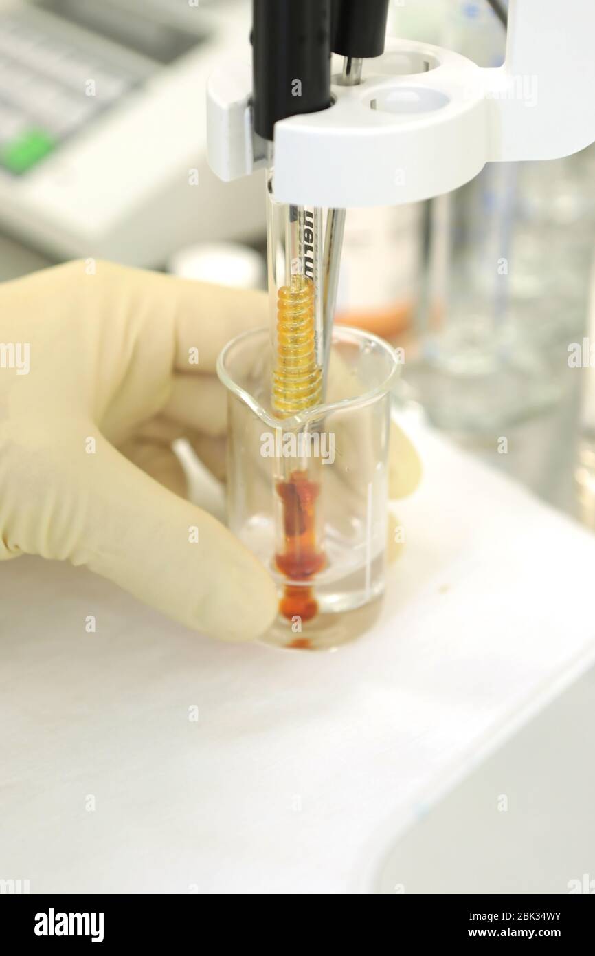 A chemist conducts a study of the stiffness of the solution. Laboratory ...