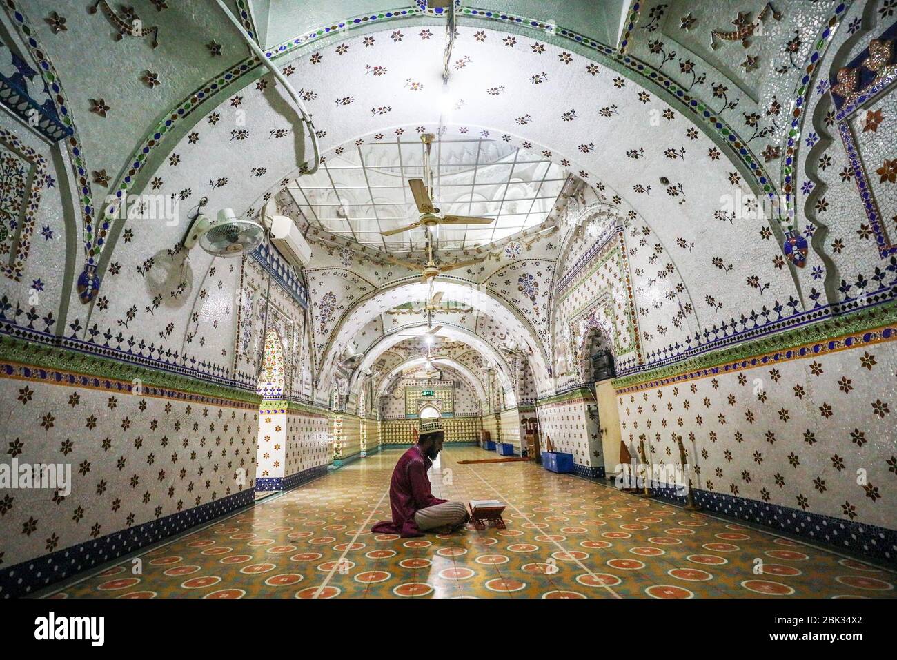Dhaka. 30th Apr, 2020. A man recites verses from the holy Quran at a ...
