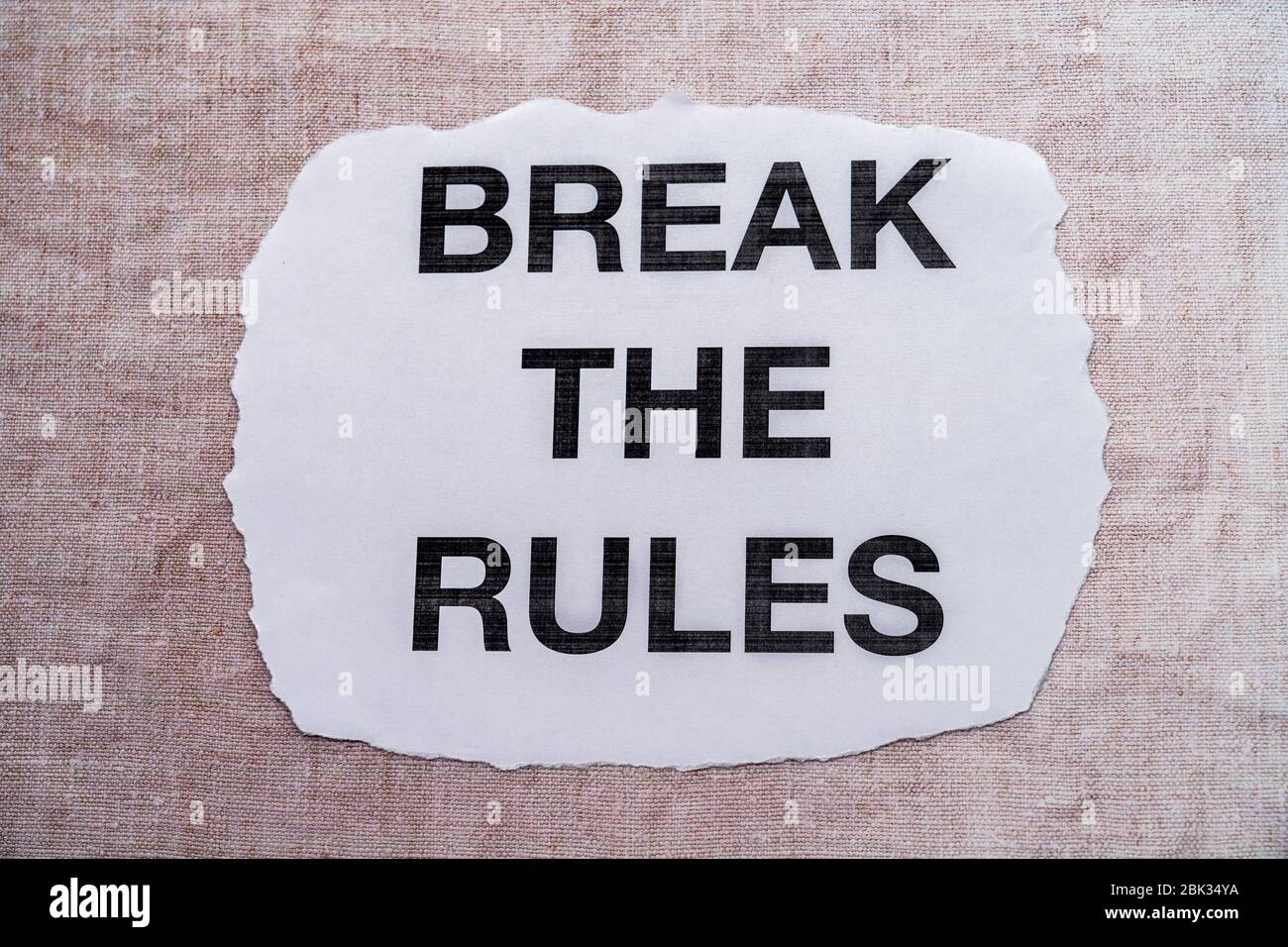 A break the rules sign printed on white paper and placed against a ...