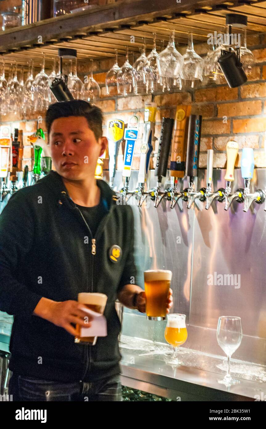 Manager Jacques Zhu busy pouring beers at World of Beer (WOB) Shanghai ...